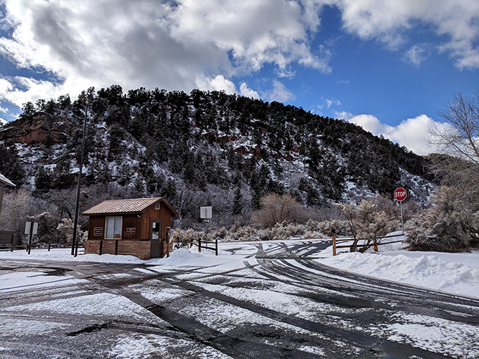 Winter transforms Rifle Falls State Park into a snow globe come to life, complete with a cozy entrance station that practically begs for a holiday card photo.