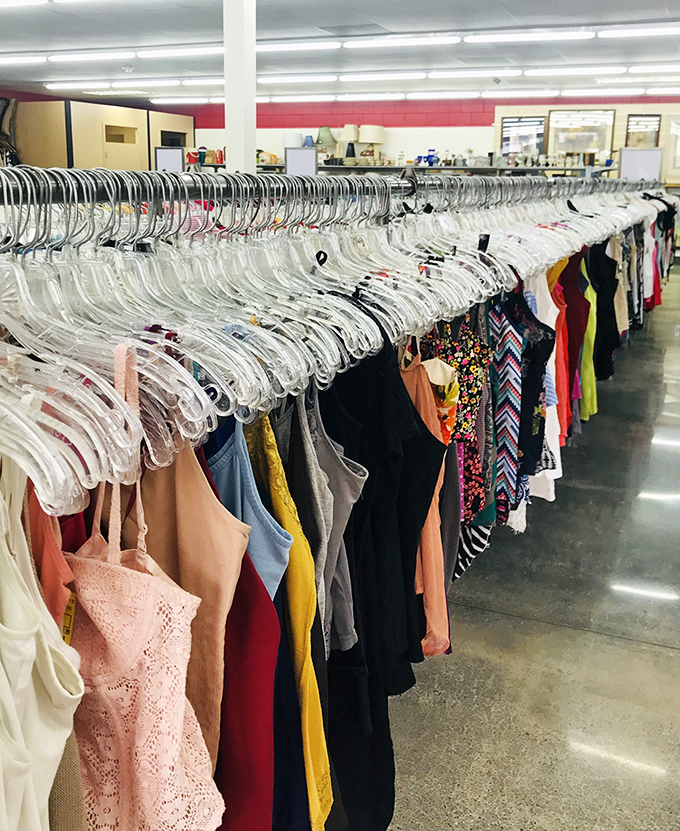 The clothing racks stretch toward infinity, a colorful textile highway where yesterday's fashion finds tomorrow's admirers at rock-bottom prices.