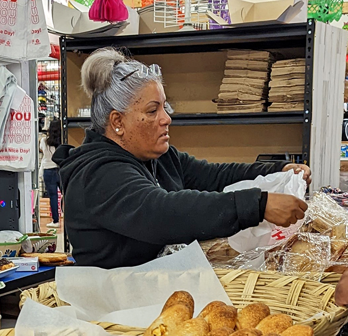 Fresh baked goods being carefully packaged by a vendor. In the hierarchy of swap meet treasures, homemade food might just be the crown jewel.