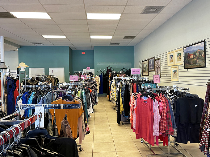 Color-coded clothing racks create a rainbow of fashion possibilities. The teal walls aren't the only pop of color in this shopping wonderland.