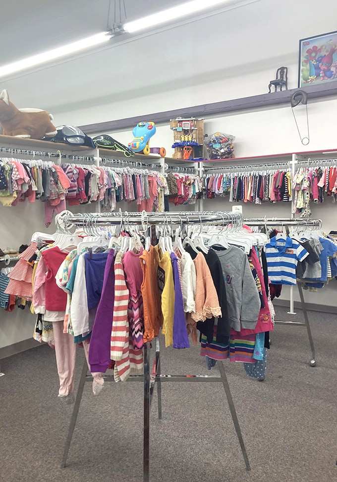 Tiny clothes hang in perfect rows, proving that outfitting fast-growing kids doesn't require refinancing your house after all.