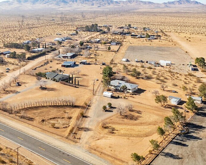 Desert homes scattered across Barstow's golden landscape, where mountains meet sky and affordable retirement awaits.