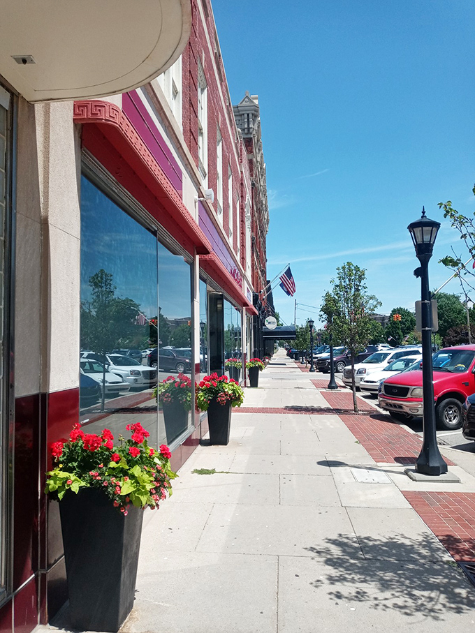 Crimson storefronts pop against pristine sidewalks like jewels in a well-curated antique collection.
