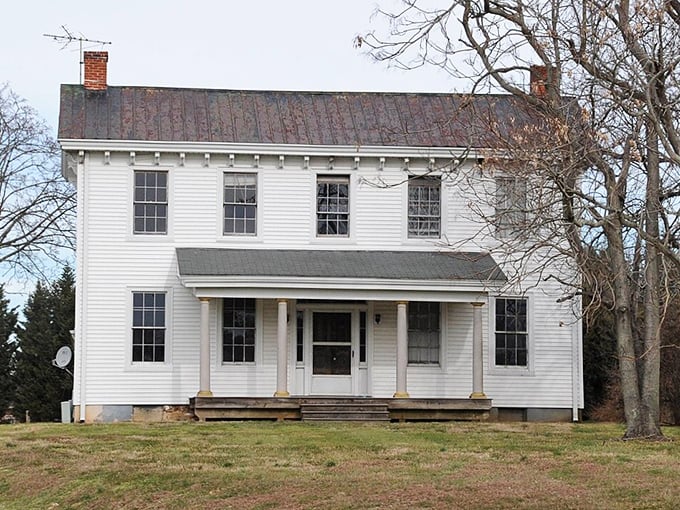 A classic white farmhouse in Bear, Delaware stands as a testament to affordable rural living with timeless charm and practical simplicity.