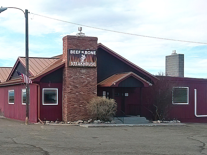 Red exterior, brick chimney, and a sign that promises exactly what you'll get: serious steak business.