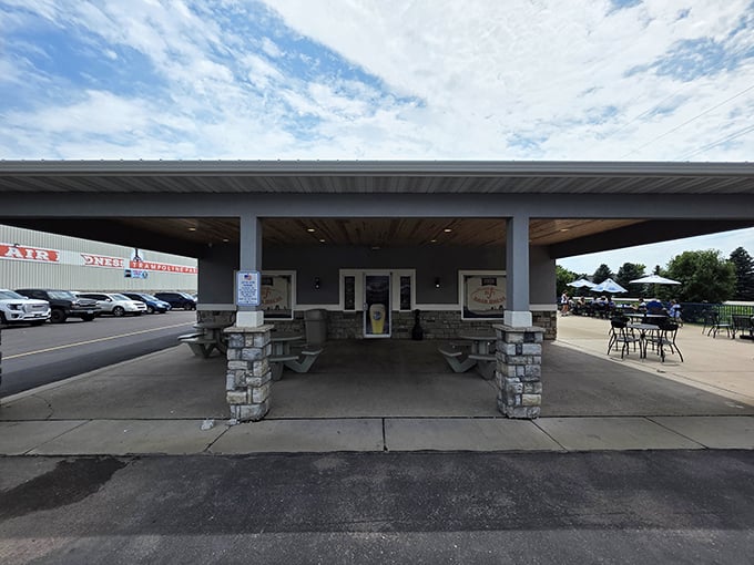 Big J's covered patio beckons like an oasis for road-weary travelers craving authentic BBQ and cold beverages together.