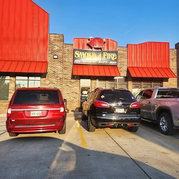 Como Smoke and Fire's bold red roof stands out like a beacon. That cartoon pig on the sign is practically winking at barbecue lovers!