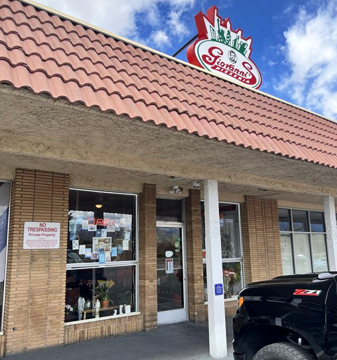 Giovanni's might look unassuming, but locals know this place is pizza royalty. The sign says it all: pizza, subs, and happiness.