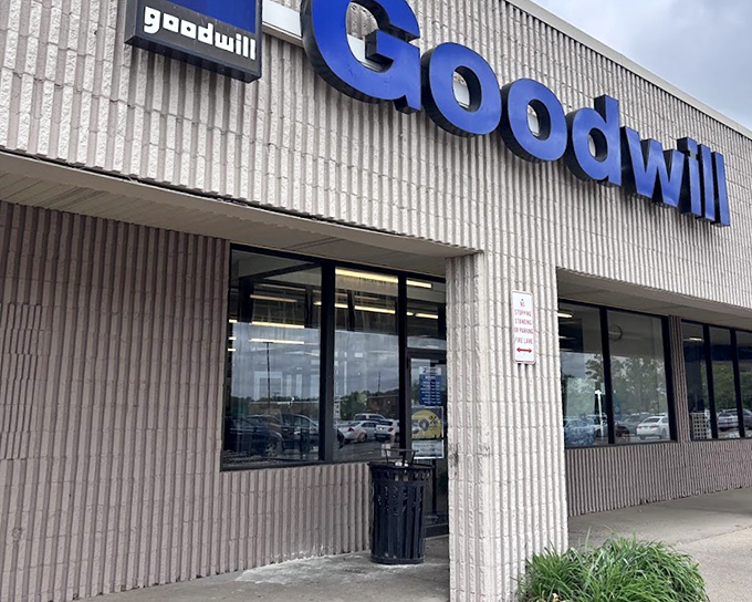 Goodwill's bold blue sign stands out against the industrial exterior, like a superhero cape for budget shoppers.