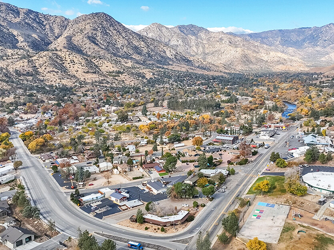 Autumn trees splash color against dramatic mountains, creating scenery that belongs on a calendar but costs nothing to enjoy.
