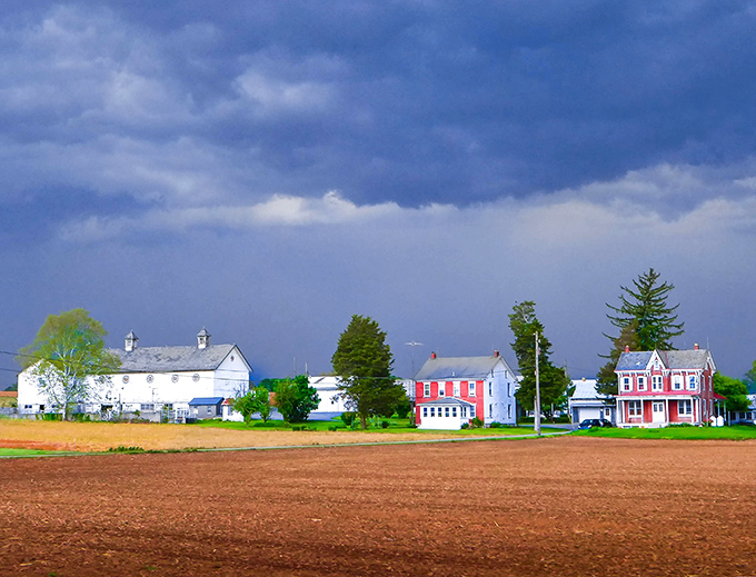 Rich farmland stretching toward colorful houses - this is America's heartland at its finest.