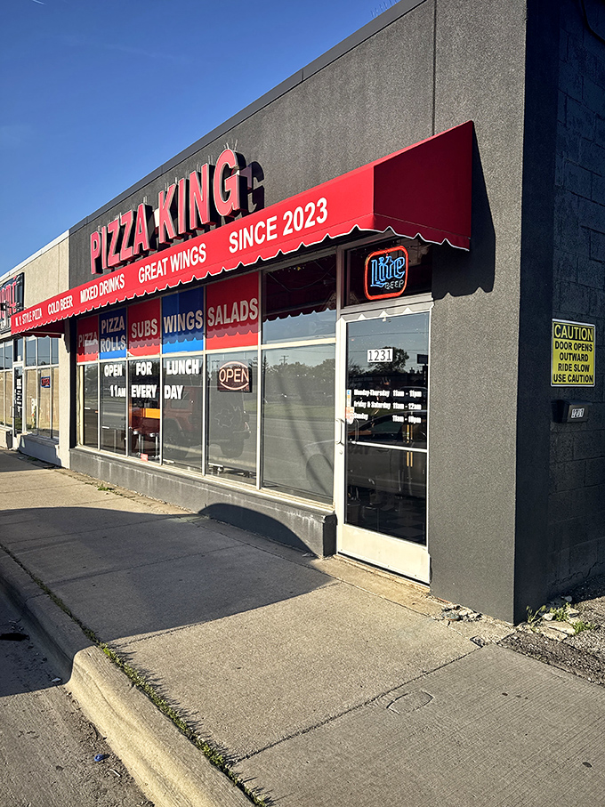 MT's Pizza King's bold red awning is like the royal cape of pizza royalty &ndash; simple, striking, and impossible to miss.