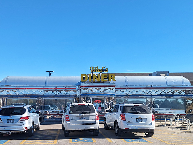 Mel's Diner's gleaming chrome exterior shines like a beacon for hungry travelers seeking authentic American breakfast classics.