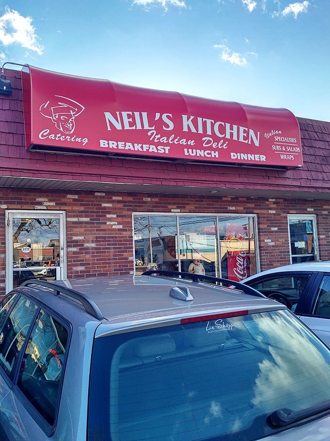 Neil's Kitchen's bold red awning signals sandwich salvation ahead. The chef illustration promises authentic Italian delights.
