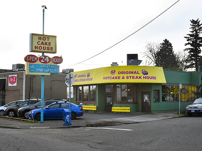 Hot Cake House's vintage sign glows with 24-hour promise &ndash; where breakfast never sleeps and neither do the griddles.