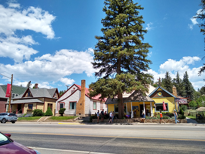 Sunshine yellow meets forest green in a rainbow row of historic homes where towering pines stand guard over mountain memories.