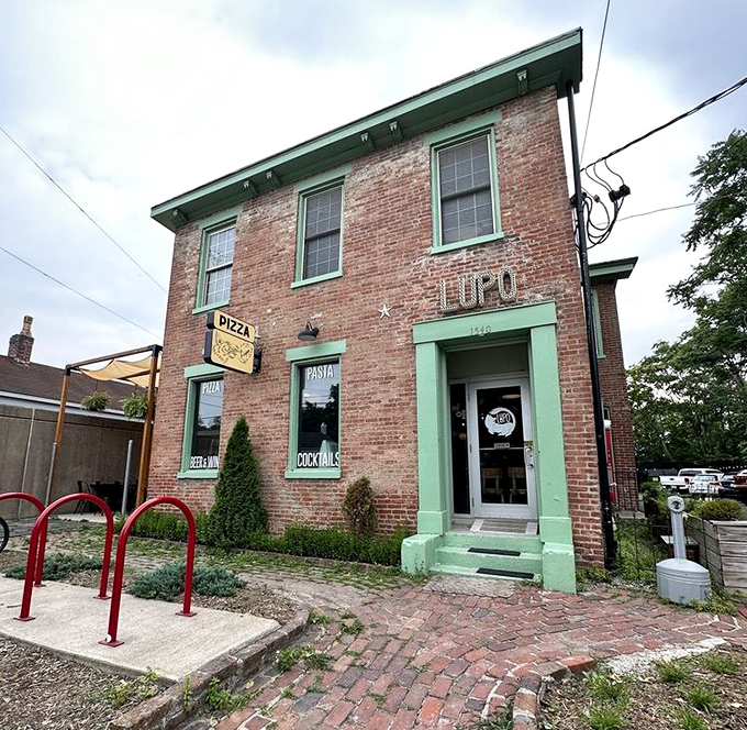 That weathered brick exterior holds decades of pizza-making wisdom and neighborhood stories.