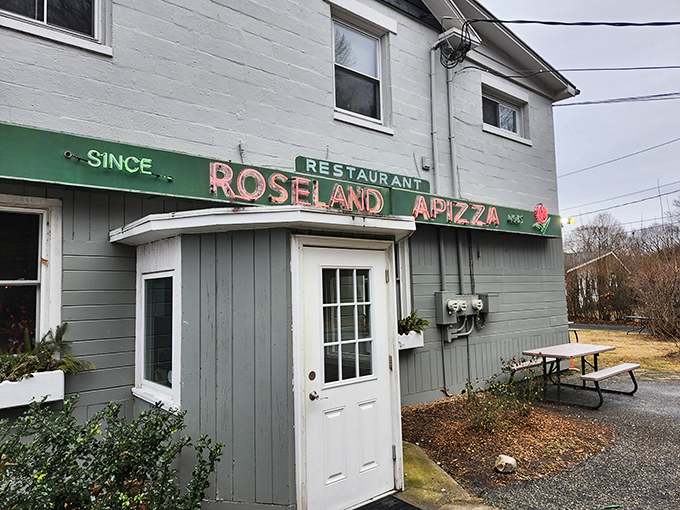 Roseland's weathered sign has guided hungry travelers for generations. That rose logo isn't just decoration&mdash;it's a family crest of pizza nobility.