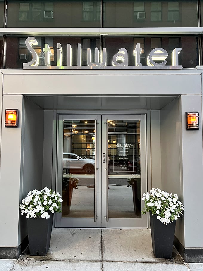 Stillwater's sleek, modern entrance with elegant white planters proves that comfort food can dress up without losing its soul.