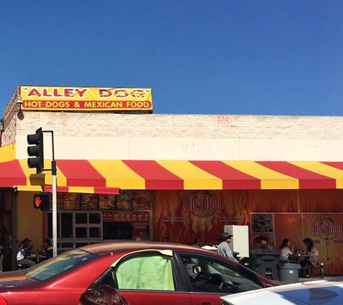 The Alley Dog's vibrant awning brings a splash of color and the promise of bacon-wrapped delights.