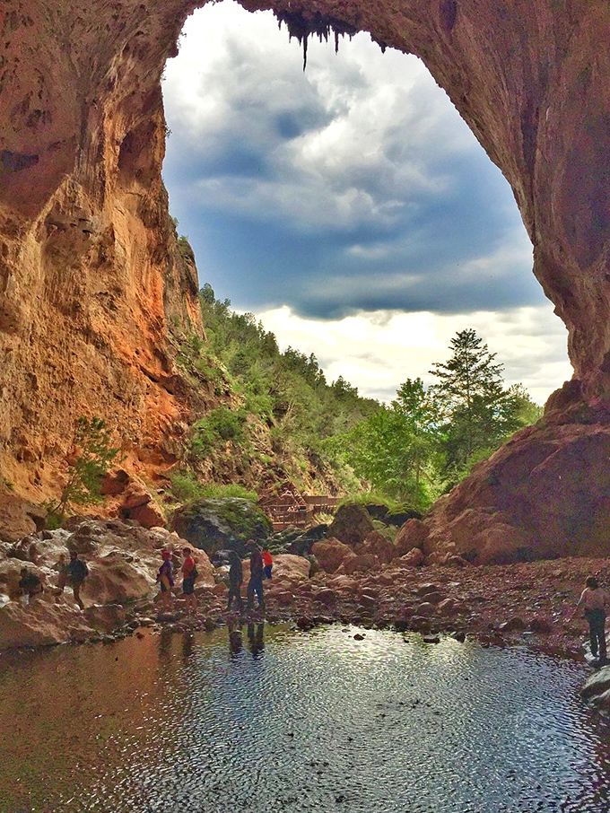 Looking up through this massive natural bridge feels like peeking through nature's own cathedral window.