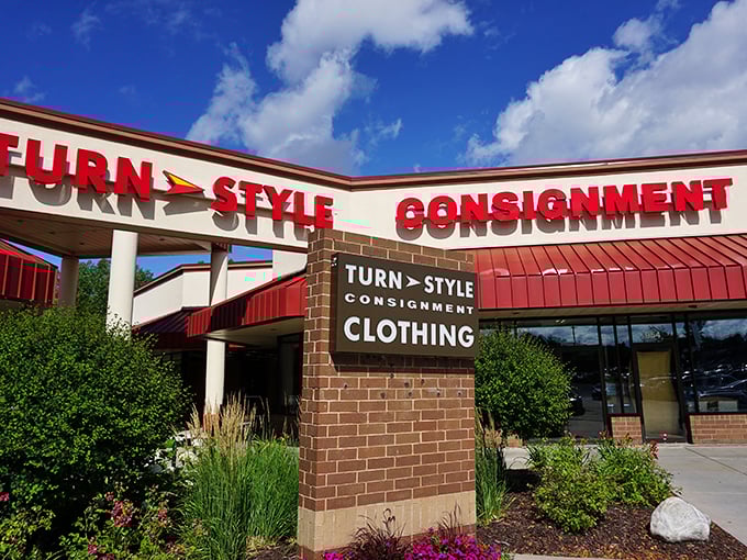 Turn Style's distinctive red signage pops against the blue sky. Consignment shopping with a touch of class awaits inside.