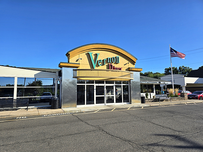 Vernon Diner's golden facade and teal lettering shine like a desert mirage for hungry travelers. That curved roof design screams "classic Americana" with every architectural line.