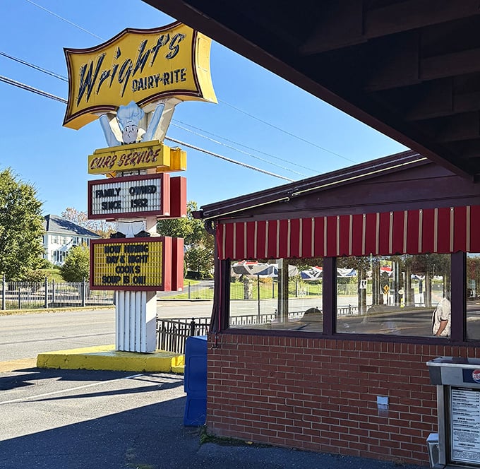 That vintage yellow sign towers like a beacon of hope for anyone who remembers when curb service was pure magic.