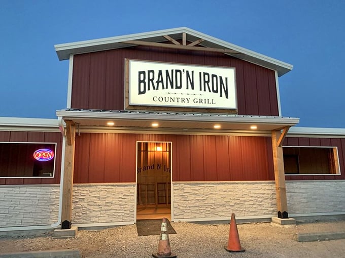 The illuminated entrance of Brand N Iron Country Grill promises hearty meals in a setting that honors its rural roots. Steak with a side of authenticity!