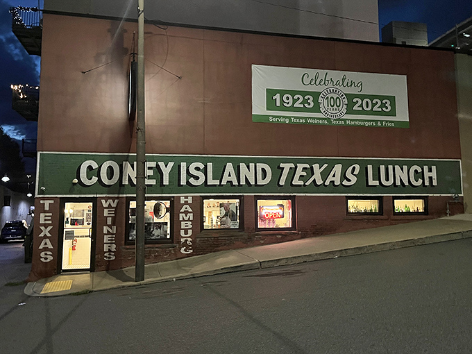 Night falls but Coney Island Lunch still shines, a beacon of hot dog history in downtown Scranton.