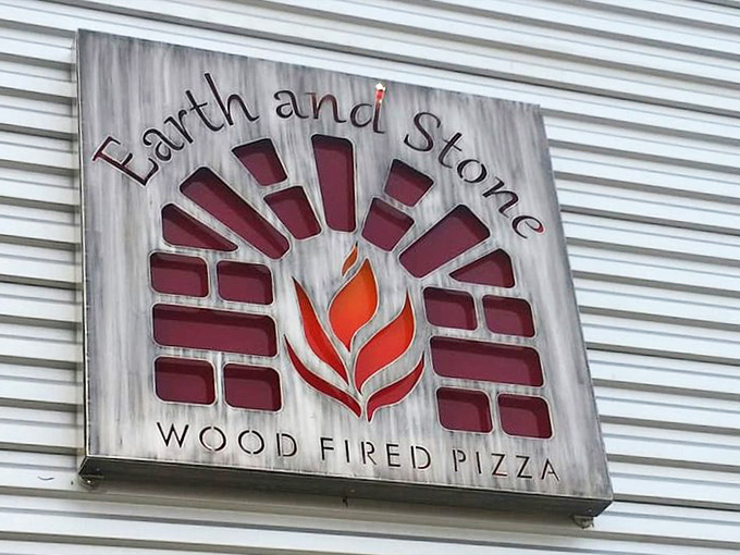 That flame logo isn't just clever branding &ndash; it's a promise of wood-fired magic happening inside this unassuming metal building.