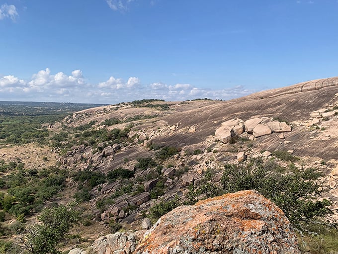 Sweeping views reward hikers who conquer this ancient rock formation, with Texas spread out like a patchwork quilt below.