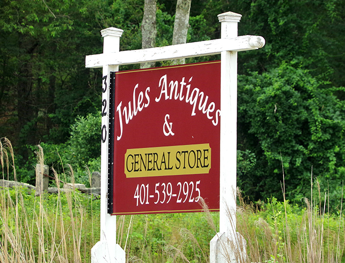 Jules Antiques' red sign against the green backdrop is like finding a cardinal in the forest&mdash;impossible to miss!