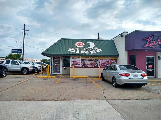 The green-roofed diner sits ready to serve, rain or shine. Those yellow safety poles protect the building from cars, not the food from eager eaters!