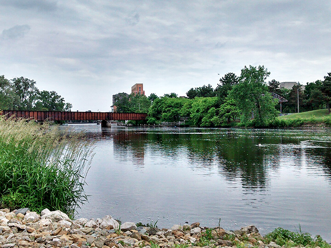 The Grand River's peaceful waters reflect a capital city where dining budgets flow as smoothly as this scenic waterway.
