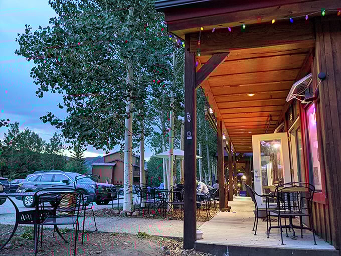 The wooden porch of Last Chance Pizza invites you to enjoy mountain views with your slice. Those colorful lights add apr&egrave;s-ski charm.
