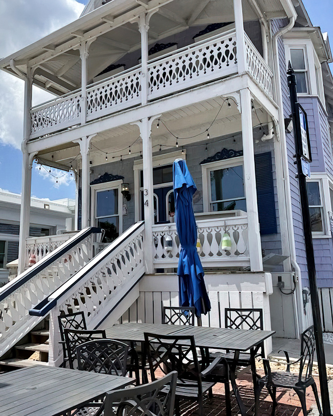 Wraparound porches and string lights create dining magic that rivals any coastal experience.