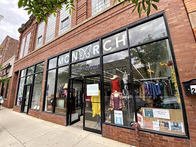 Mannequins in the window stand guard at Monarch Thrift Shop, showcasing fashion finds that defy their secondhand status.