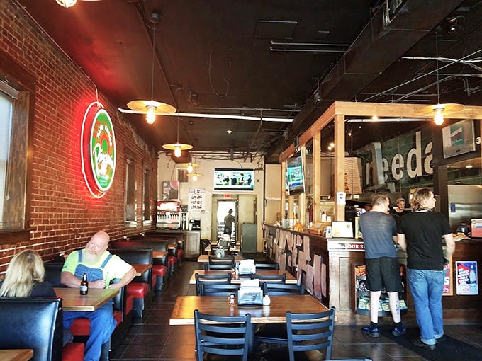 Exposed brick and warm lighting create the perfect atmosphere for serious pizza conversations.