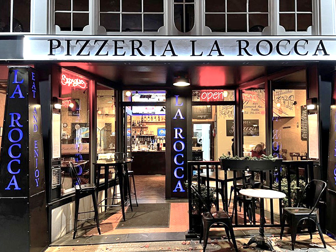 Evening transforms La Rocca into an intimate pizza sanctuary where conversations flow as freely as the wine.