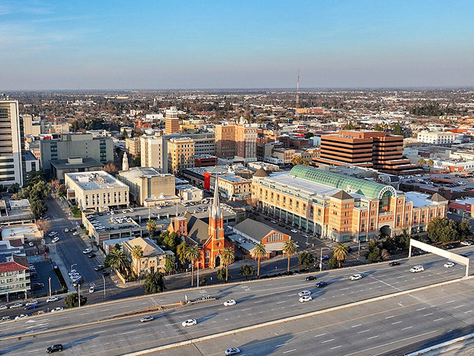 The heart of Stockton unfolds from above, with the city's downtown buildings clustered near the shimmering waterway that defines it.