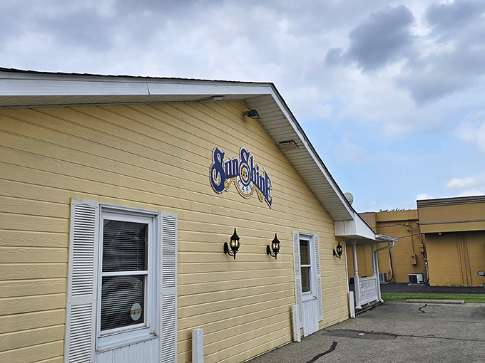 Warm porch lights welcome early risers to Sunshine Cafe. The charming cottage vibes promise homestyle cooking inside.