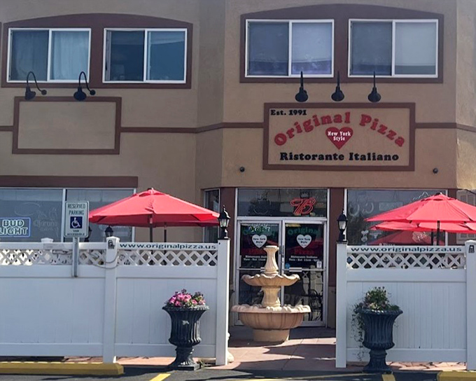 The fountain and outdoor seating area turn a simple strip mall pizzeria into a charming Italian-American oasis.