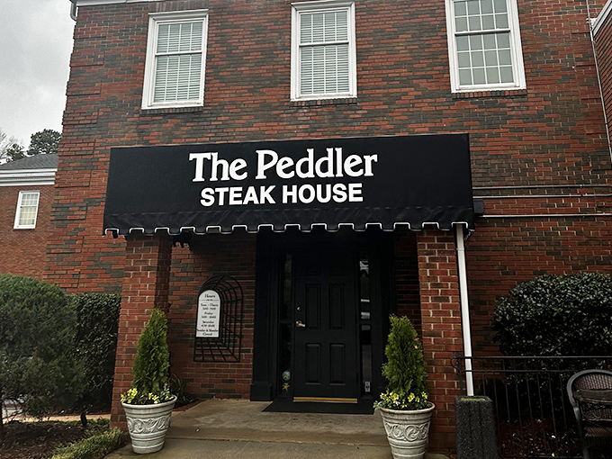 Even in daylight, The Peddler's understated charm hints at the steakhouse treasures waiting inside.