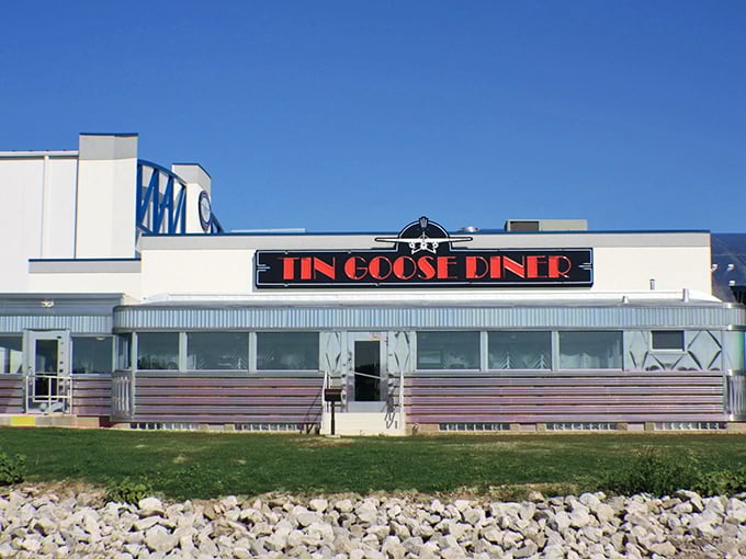 Red signage pops against silver siding at the Tin Goose, where breakfast is served with a side of aviation history.