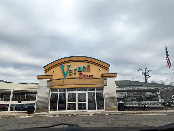 Even under cloudy skies, Vernon Diner's distinctive yellow and teal colors refuse to be ignored. This Connecticut landmark stands ready to serve, rain or shine.
