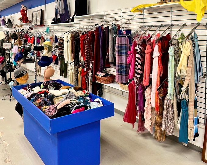 The accessories aisle: where scarves dance with hats in a colorful ballet of possibilities. That blue bin holds tomorrow's favorite fashion statement.