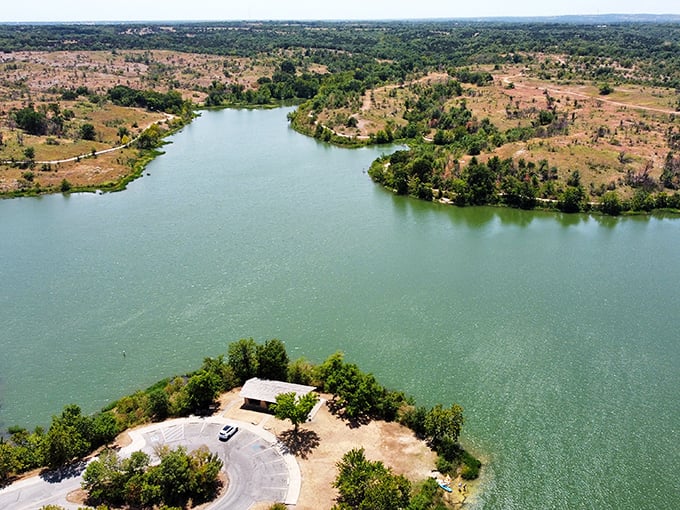 The Lake of the Arbuckles stretches like a mirror beneath Oklahoma skies, reflecting clouds that seem to be showing off just for you.