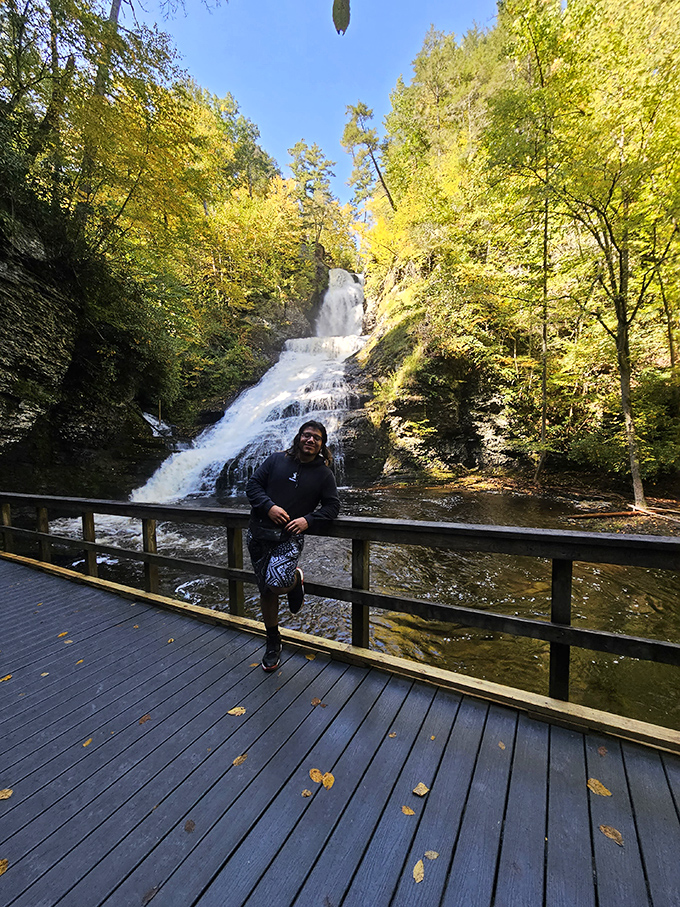 Fall foliage frames the falls like nature's own Instagram filter, proving autumn in the Poconos is unbeatable.