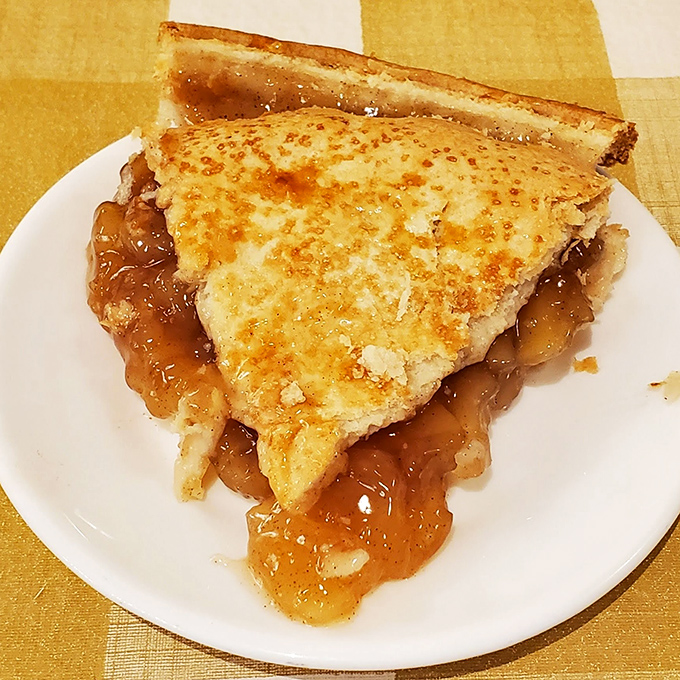 Apple pie that doesn't need Instagram filters—just look at that golden crust and the way the filling escapes like delicious lava.